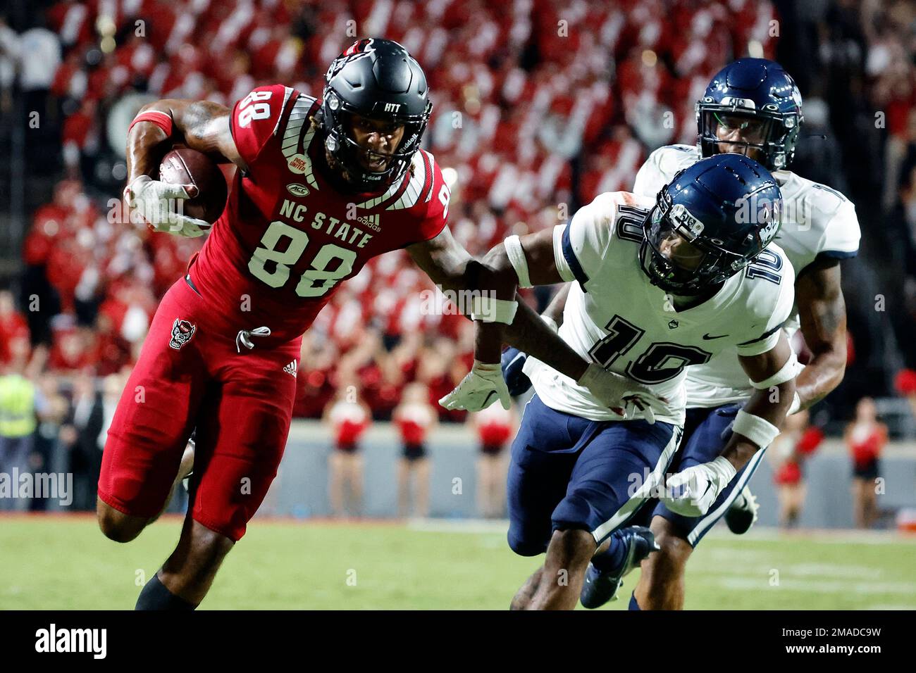 North Carolina State's Devin Carter (88) stiff arms Connecticut's Cale ...