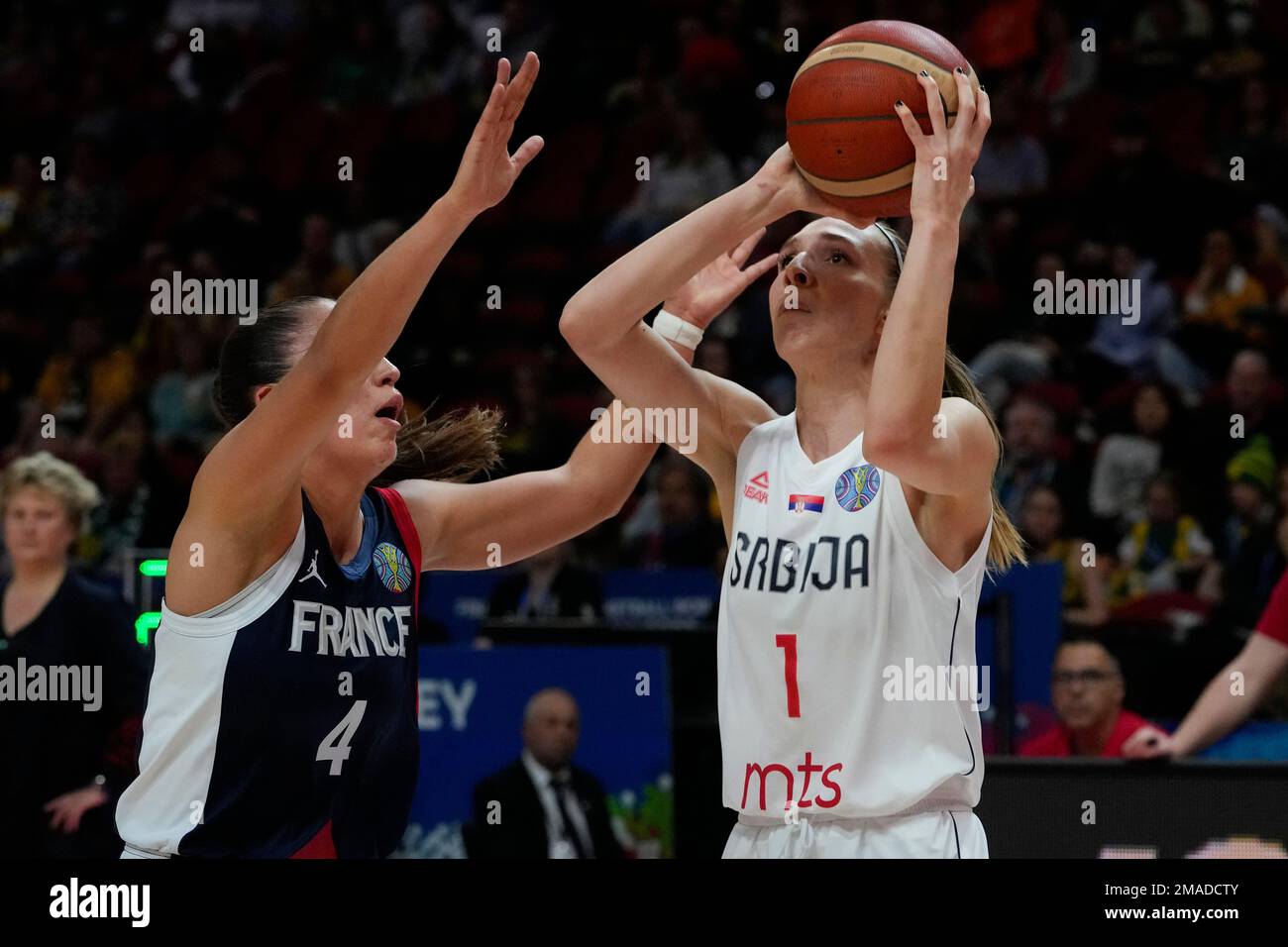 Serbia's Ivana Raca takes a shot at goal as France's Marine Fauthoux ...