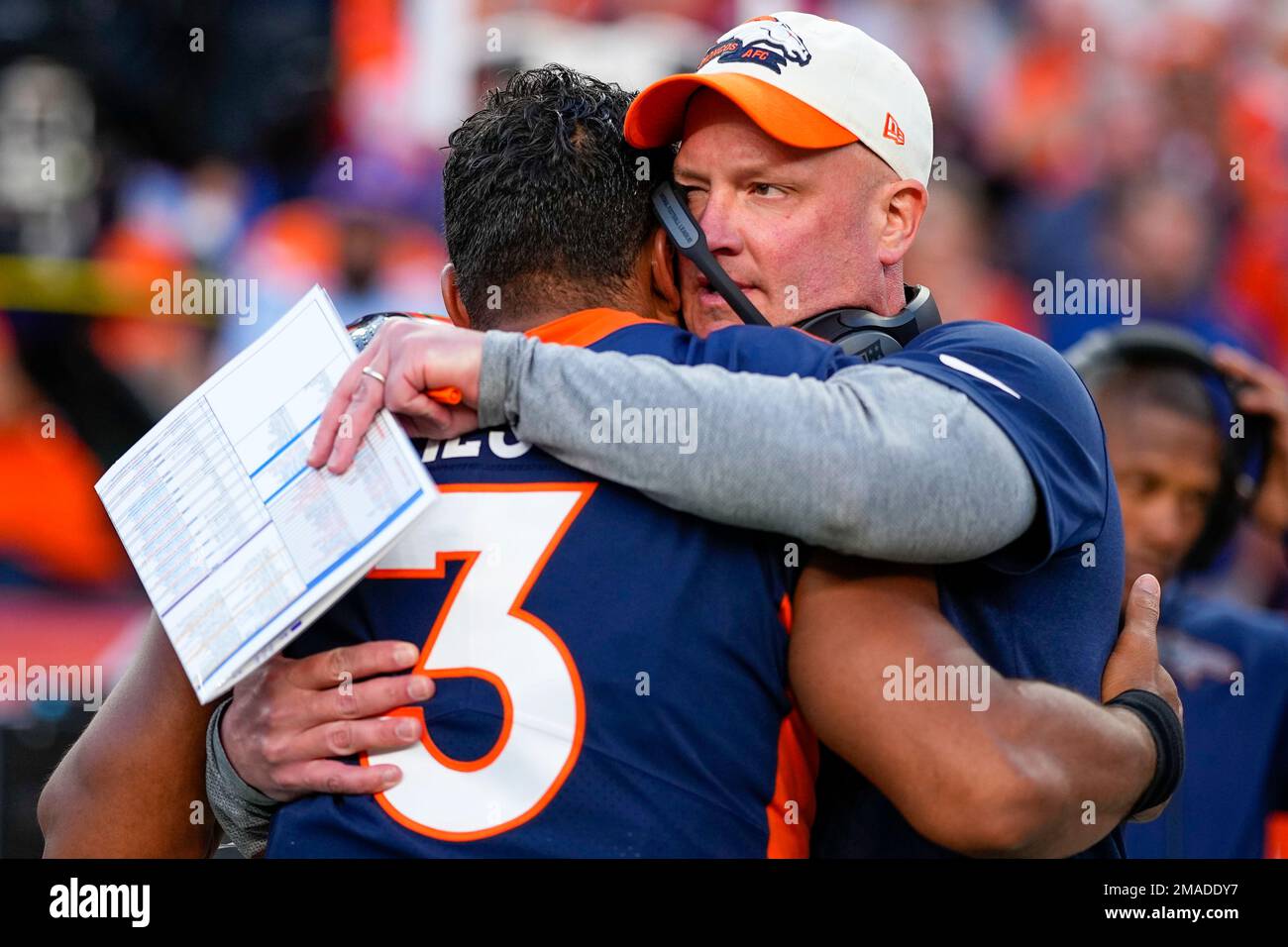 Denver Broncos head coach Nathaniel Hackett hugs quarterback Russell ...