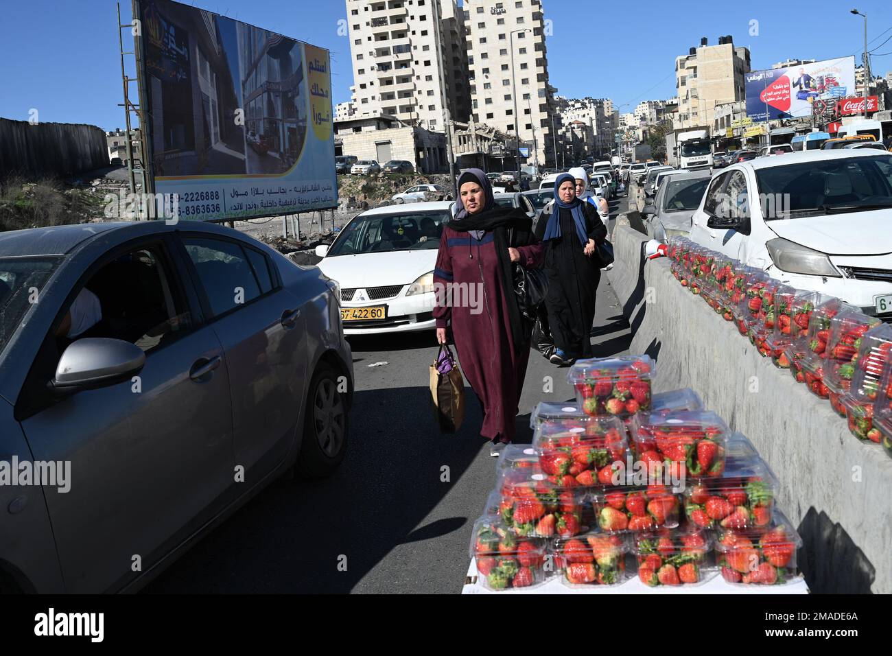 Qalandiya Checkpoint, West Bank. 19th Jan, 2023. A vendor sells ...