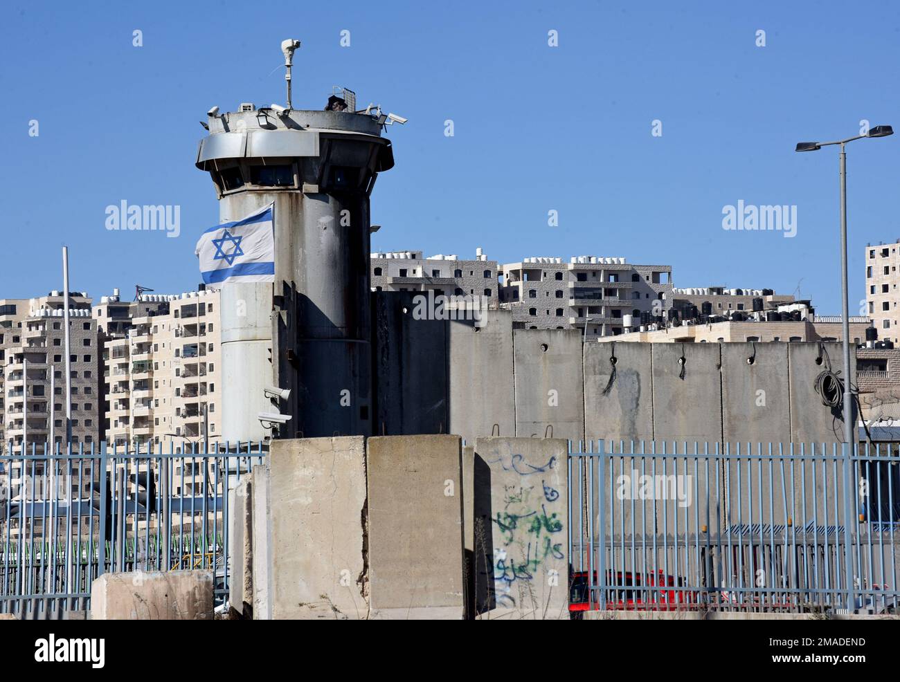 Qalandiya Checkpoint, West Bank. 24th June, 2014. An Israeli flag hangs ...