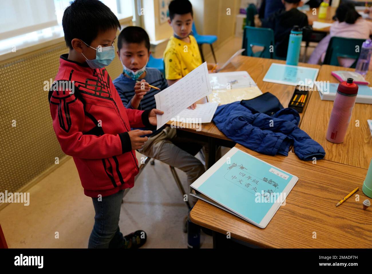 Fourth grade math students look over an exercise at the Alice Fong Yu ...
