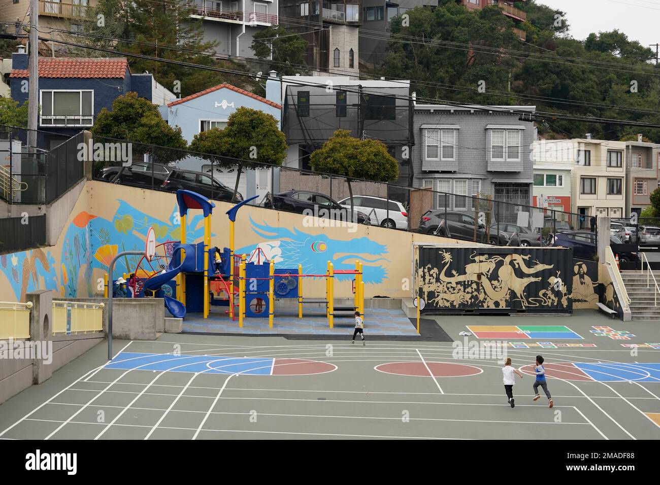 Two boys run across the playground at the Alice Fong Yu school in San ...