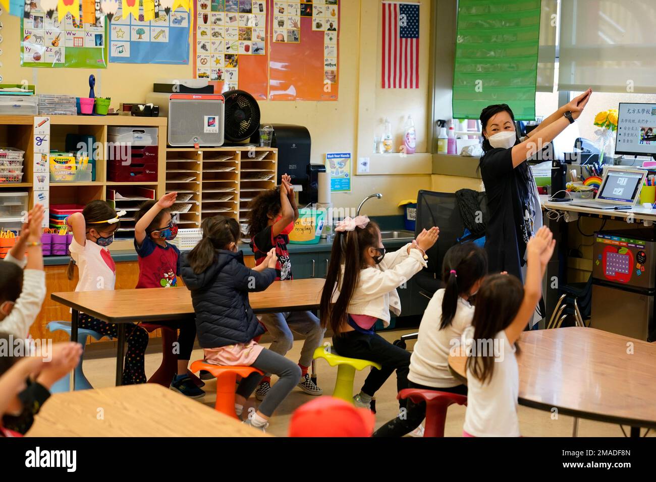First grade teacher Suzy Tom leads a class and demonstrates the order ...