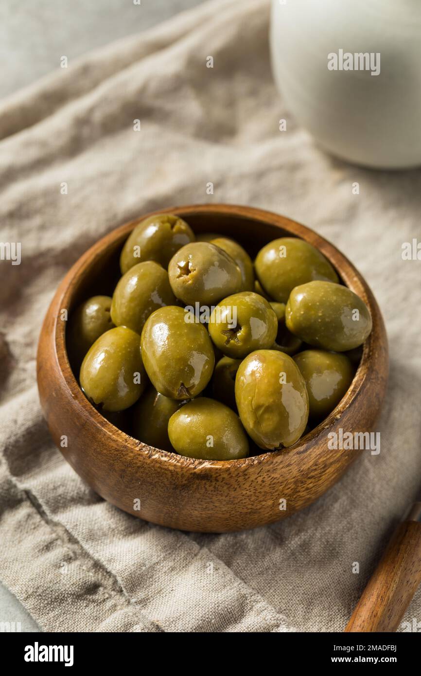 Raw Green Organic Marinated Olives in Oil Stock Photo - Alamy