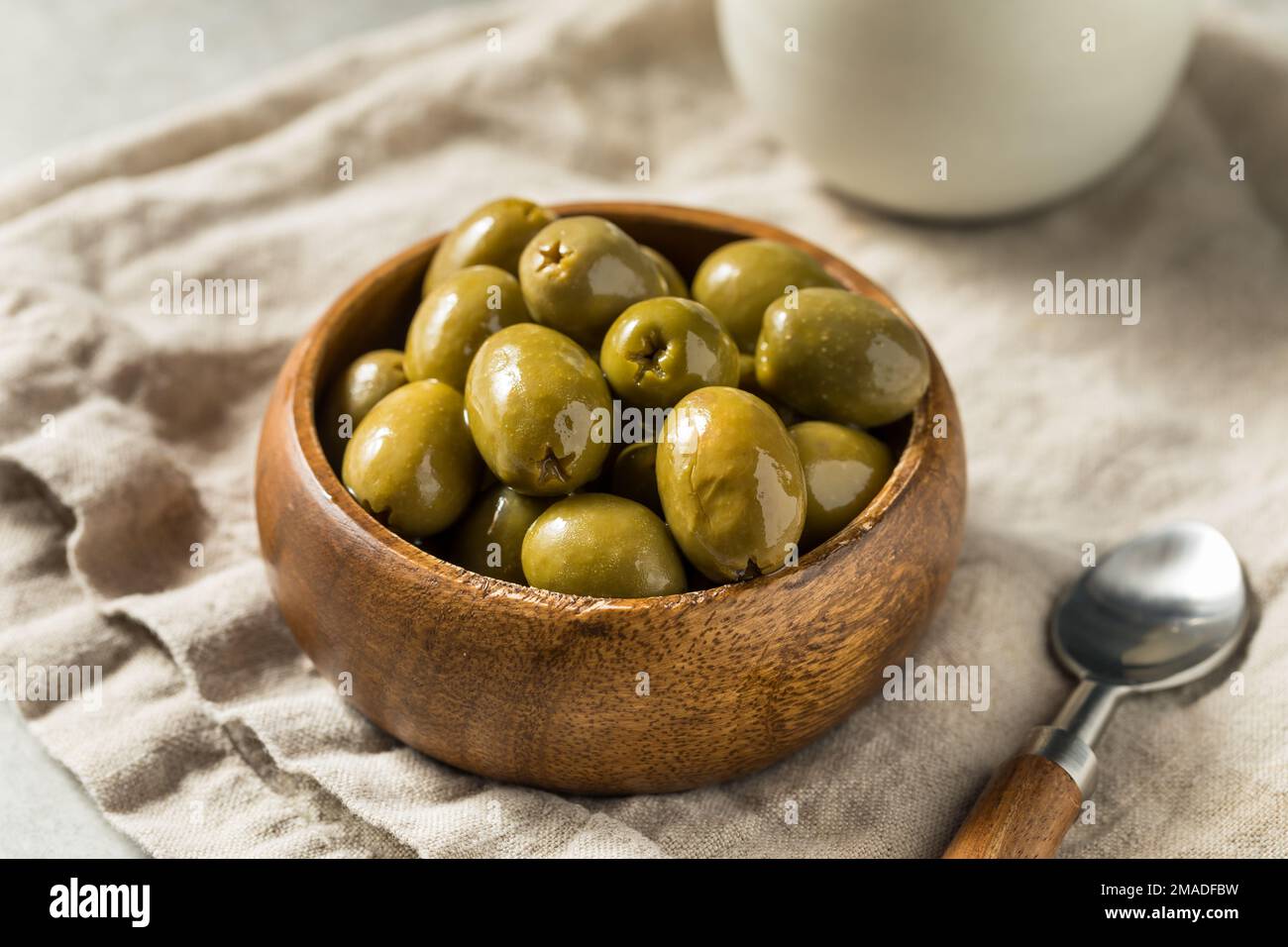 Raw Green Organic Marinated Olives in Oil Stock Photo - Alamy