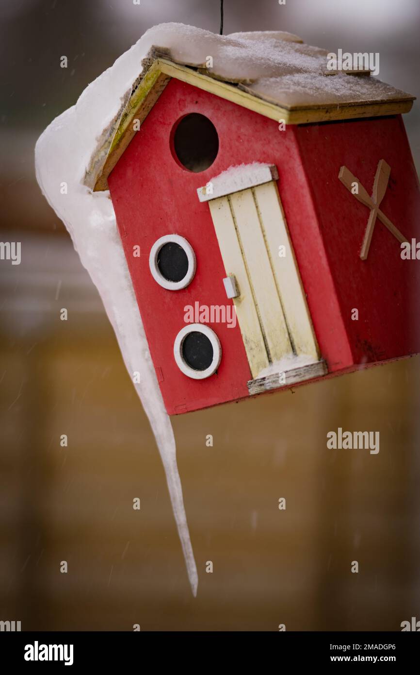 Red Bird House Covered In Ice Stock Photo - Alamy