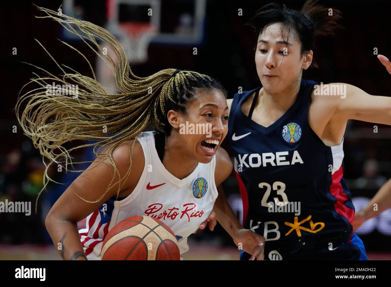 Puerto Rico's Arella Guirantes, left, runs past South Korea's Kim Danbi ...