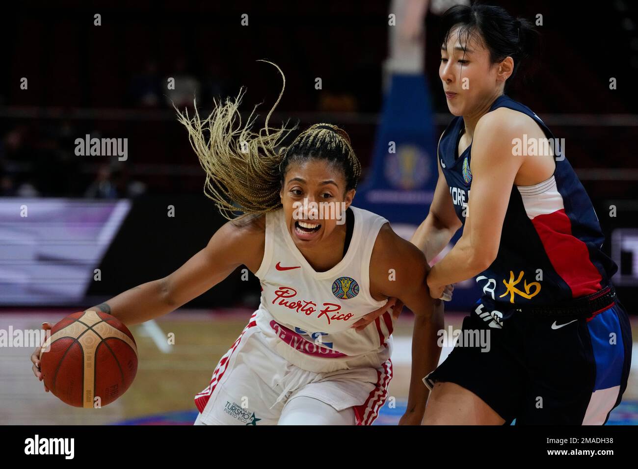 Puerto Rico's Arella Guirantes, left, runs past South Korea's Kim Danbi ...