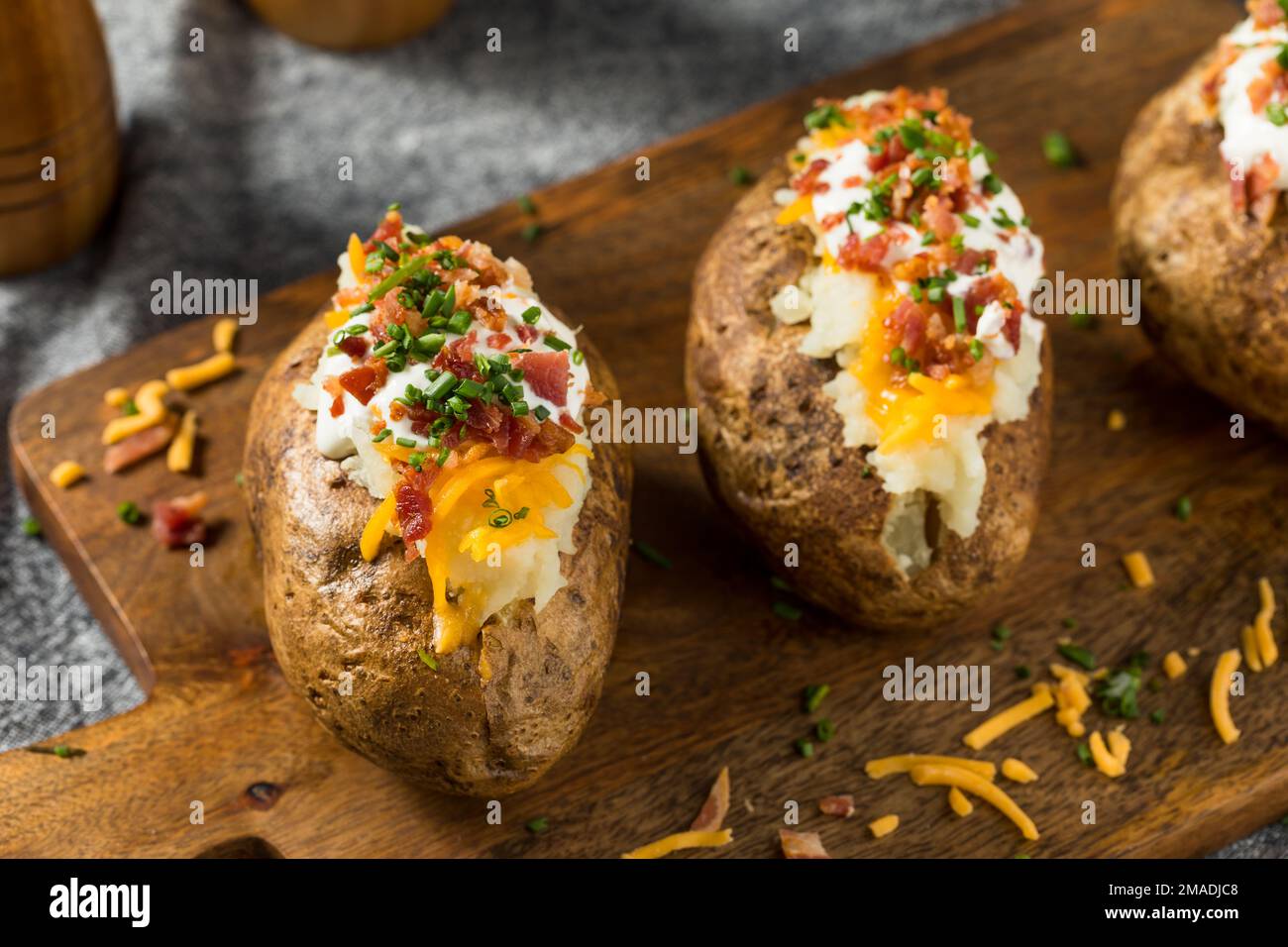 Homemade Loaded Baked Potatoes with Bacon Cheddar and Sour Cream Stock ...