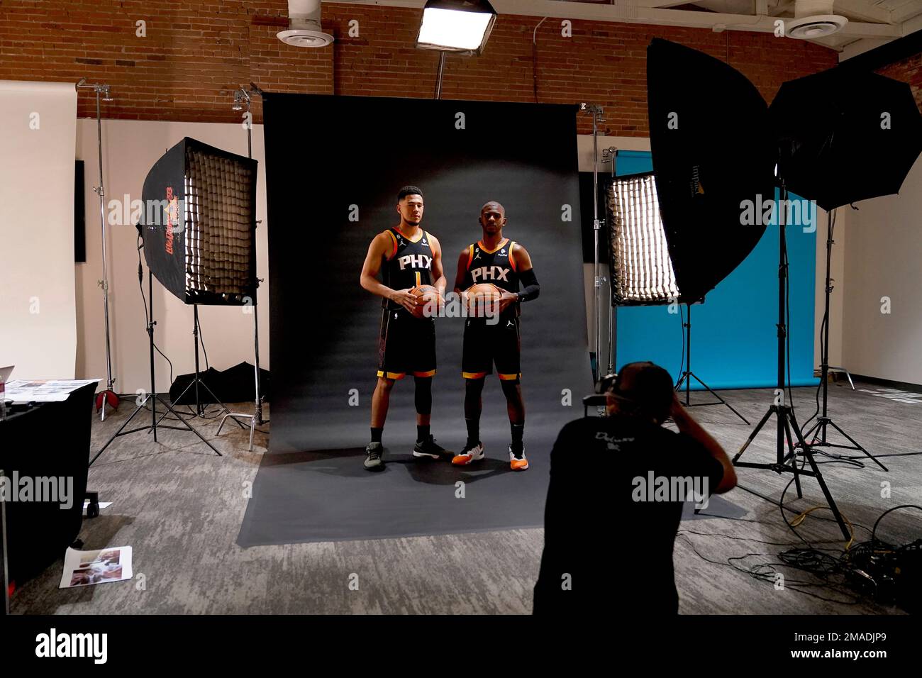 Phoenix Suns' Chris Paul, right, and Devin Booker pose for a photo with ...