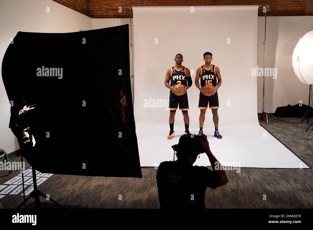 Phoenix Suns' Chris Paul, left, and Cameron Payne pose for a photo with ...