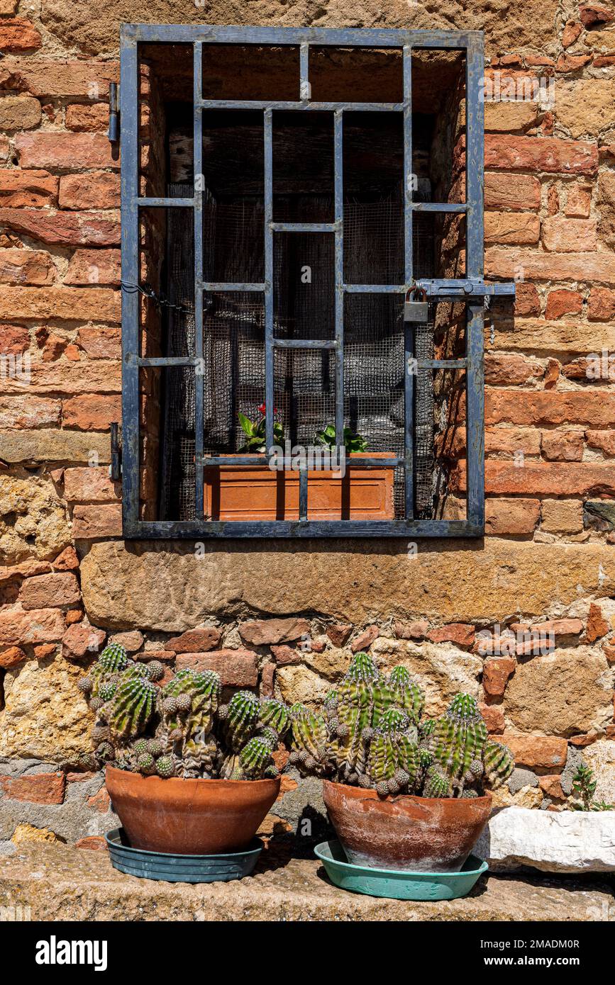 Metal-grilled window in the historic town Pienza in the Val d'Orcia in ...