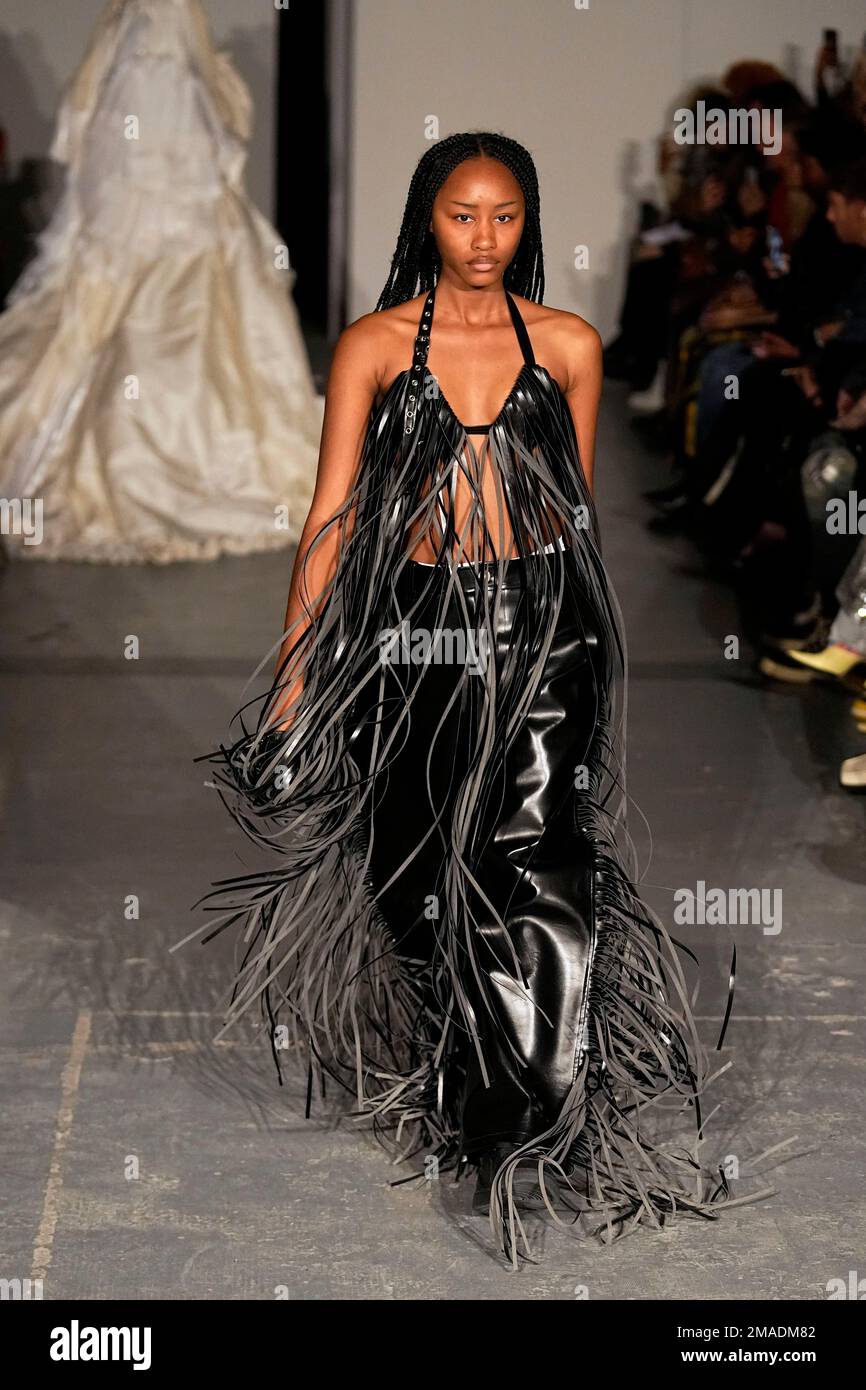 A model wears a creation by designers Patric DiCaprio and Bryn ...