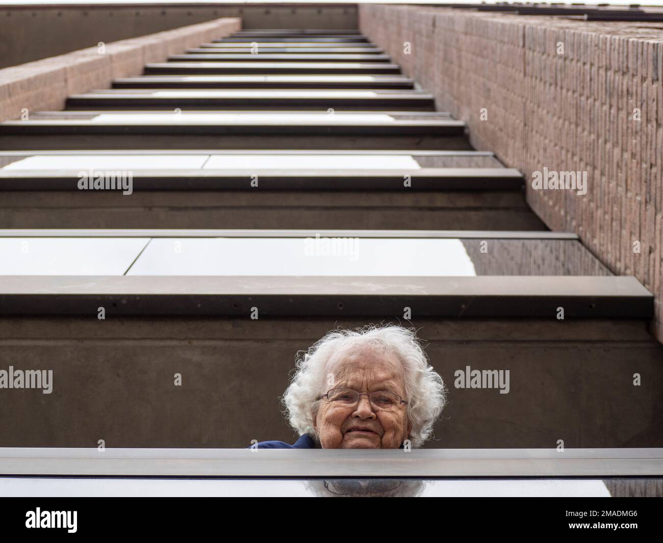 Retirement home in Pandemic Lockdown: A senior woman stares out from ...