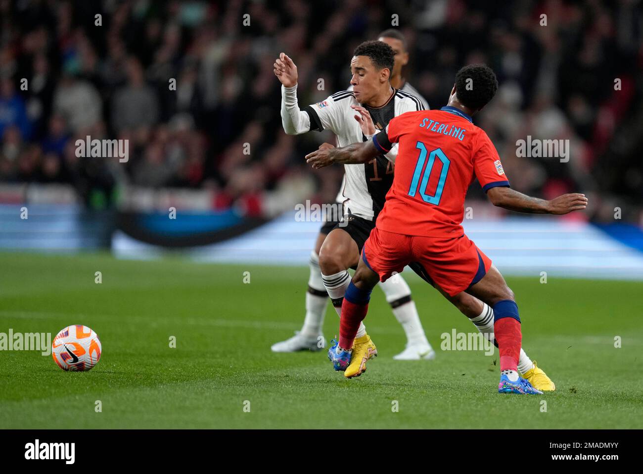 Germany's Jamal Muslala, left,, challenges for the ball with England's ...
