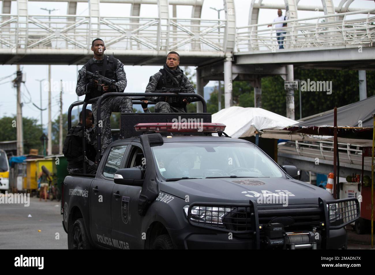 Police from the Dog Action Battalion patrol the Complexo da Mare favela ...