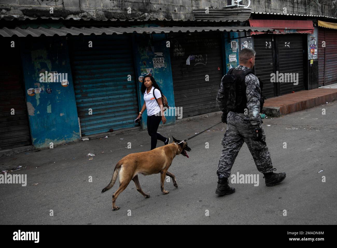 Police from the Dog Action Battalion patrol the Complexo da Mare favela ...