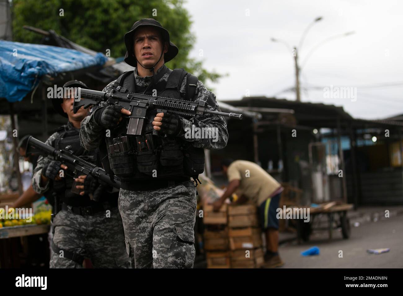 Police patrol the Complexo da Mare favela during an operation targeting ...