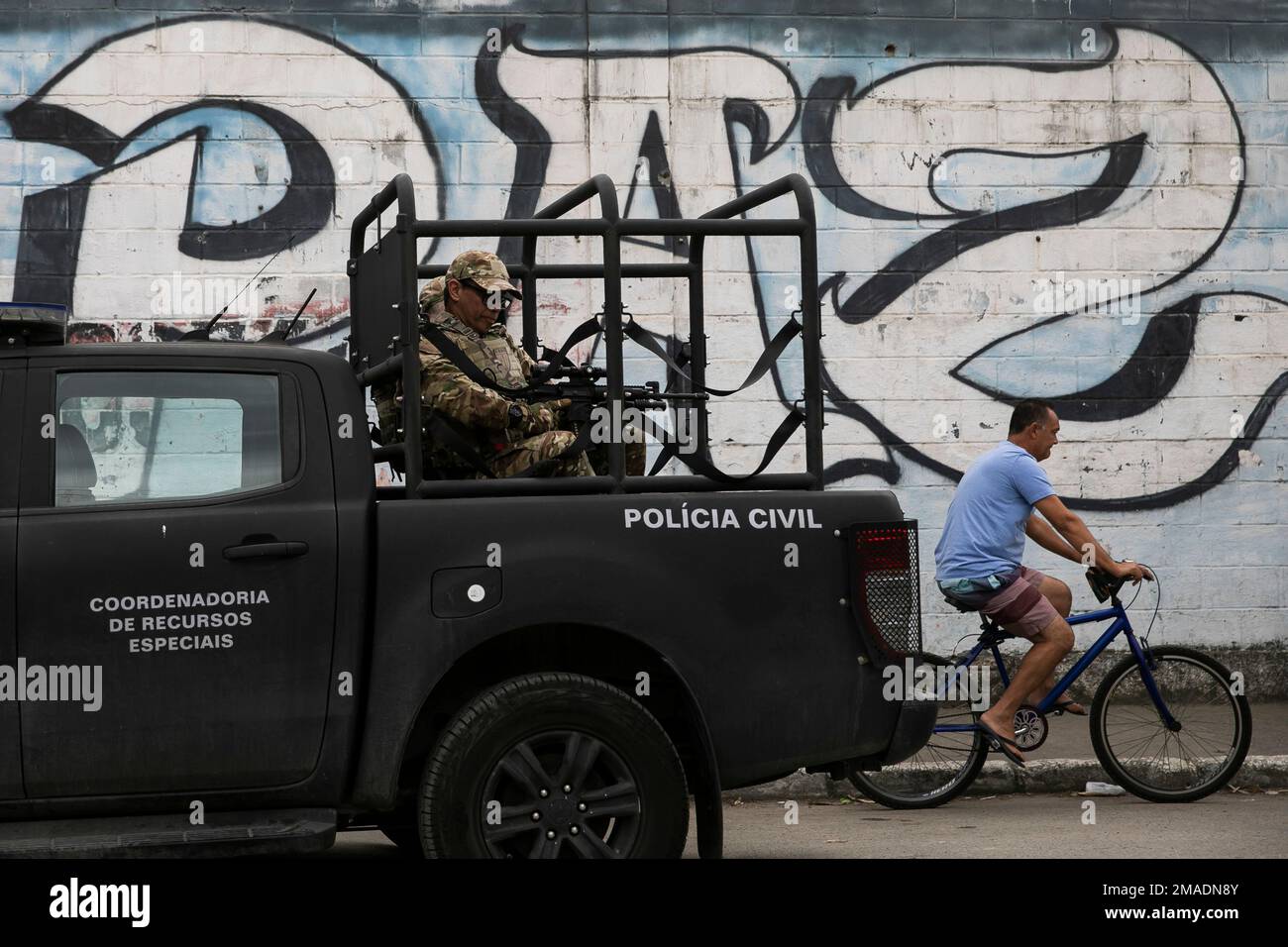 Police patrol the Complexo da Mare favela during an operation targeting ...