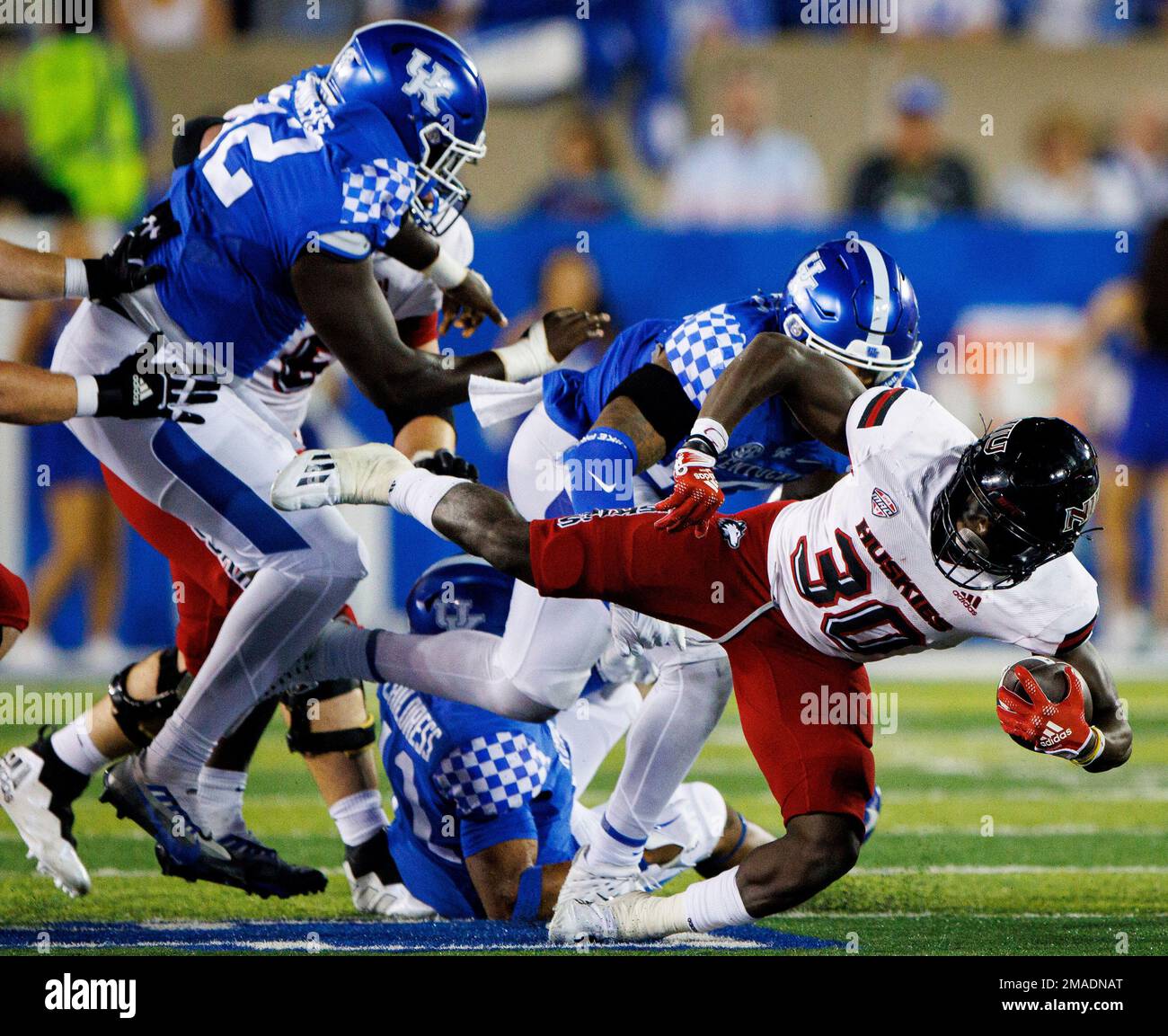 Northern Illinois running back Harrison Waylee (30) is brought down by ... Northern Illinois running back Harrison Waylee (30) is brought down by ...
