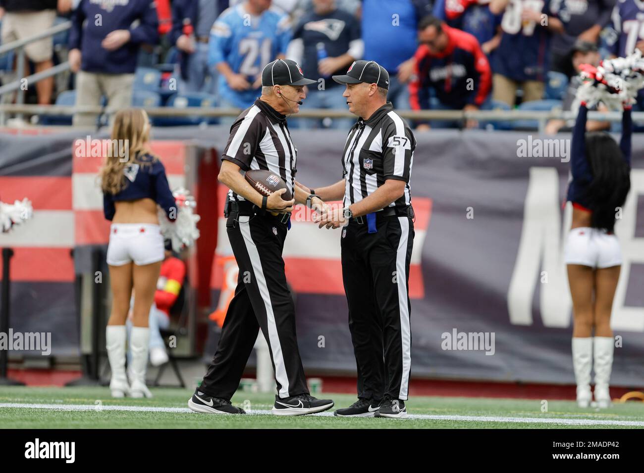 Line judge Mark Perlman, left, and field judge Joe Blubaugh (57) talk ...
