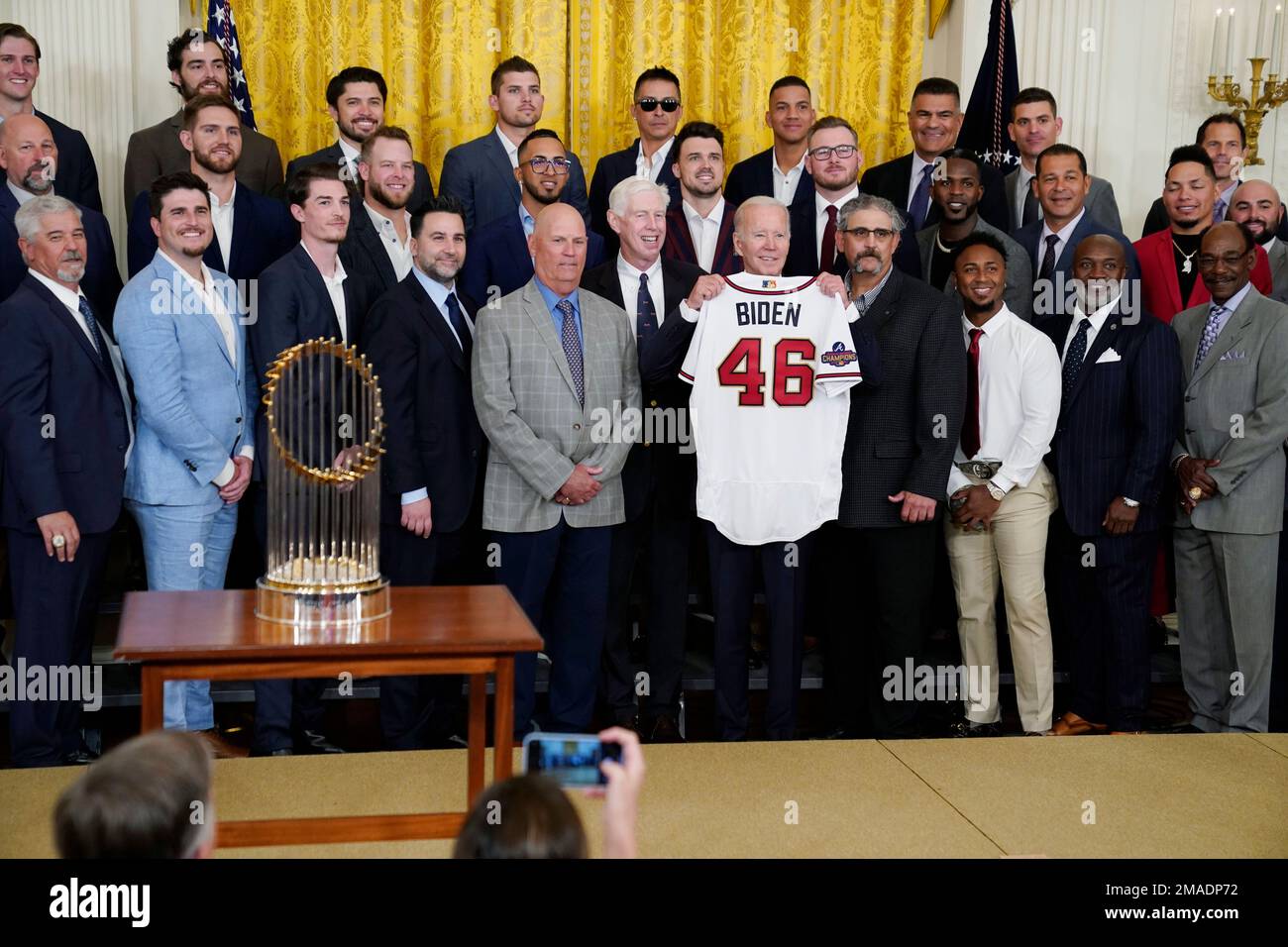 President Joe Biden holds an Atlanta Braves jersey during an event ...