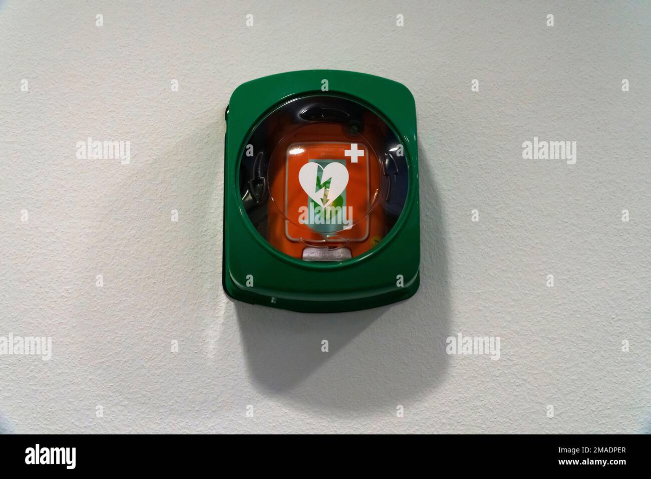First aid cabinet on an office wall with various pills and medications ...