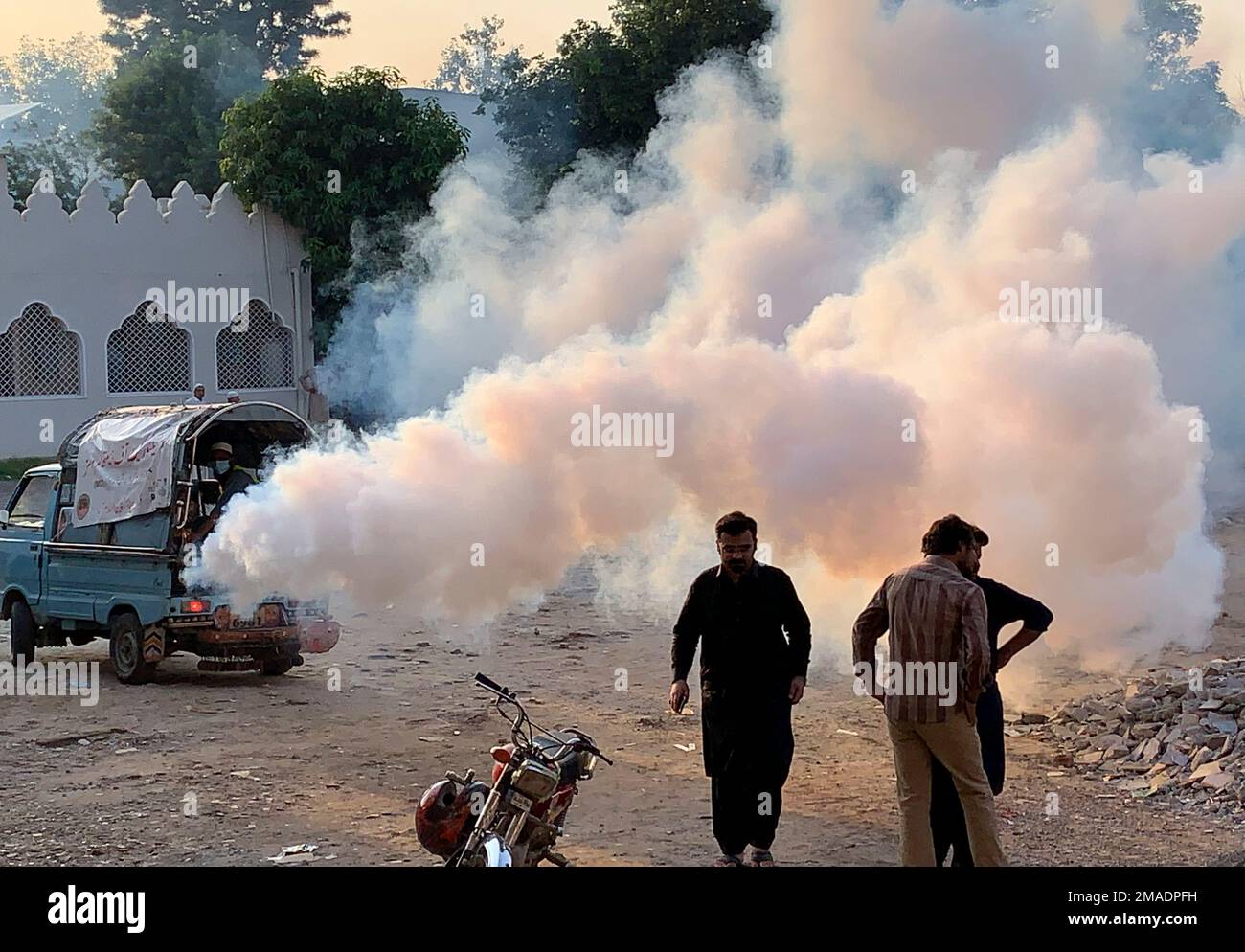 Pakistani health workers fumigate to kill mosquitos in an effort to ...
