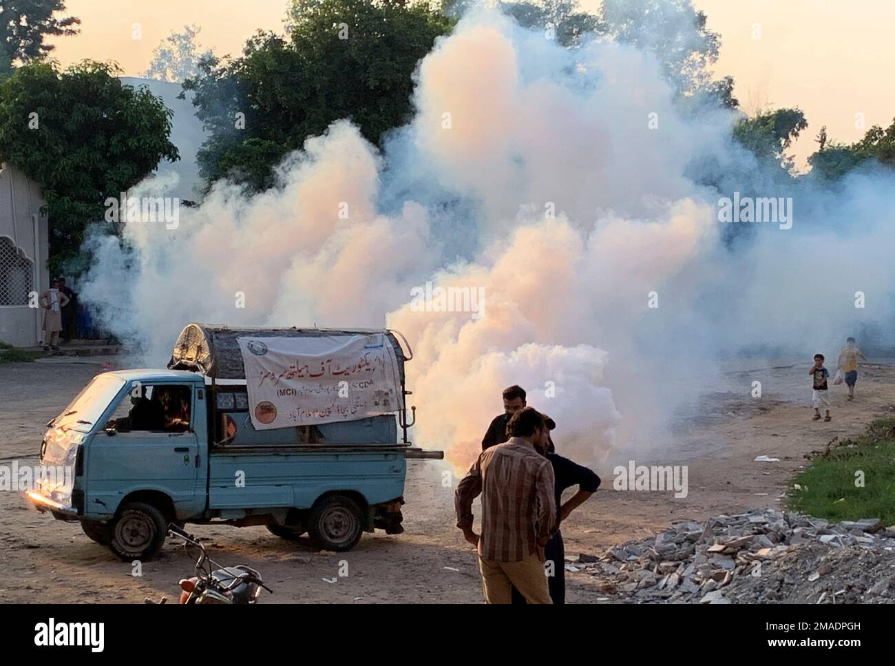 Pakistani health workers fumigate to kill mosquitos in an effort to ...