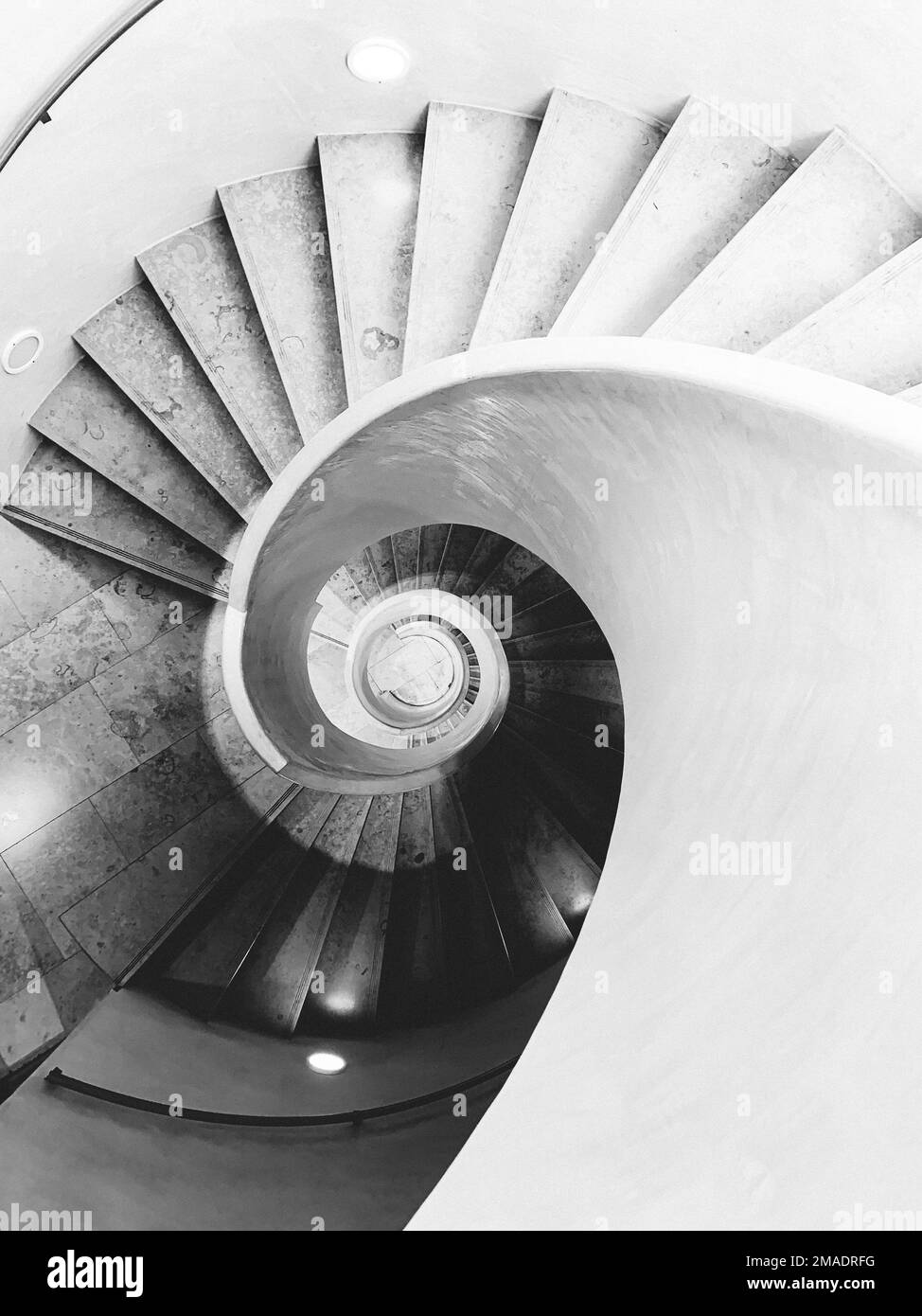 A high-angle shot of round stairs in black and white Stock Photo - Alamy