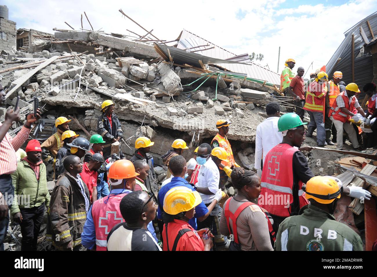 Rescurers search through a multi-storey collapsed apartment building in ...