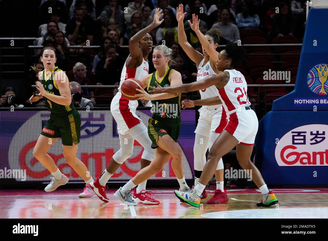Australia's Kristy Wallace passes the ball as she is surrounded by ...
