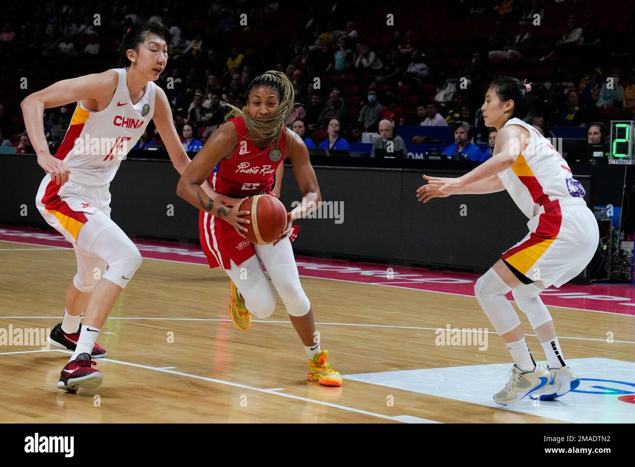 Puerto Rico's Arella Guirantes runs between China's Han Xu, left, and ...