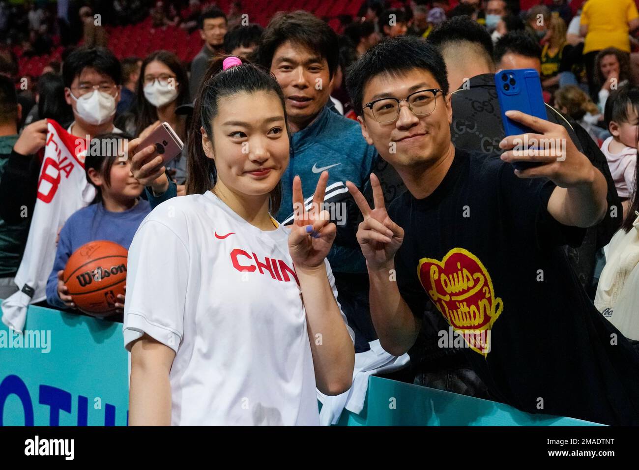China's Li Meng poses for a selfie with fans following during her game at the women's Basketball ...