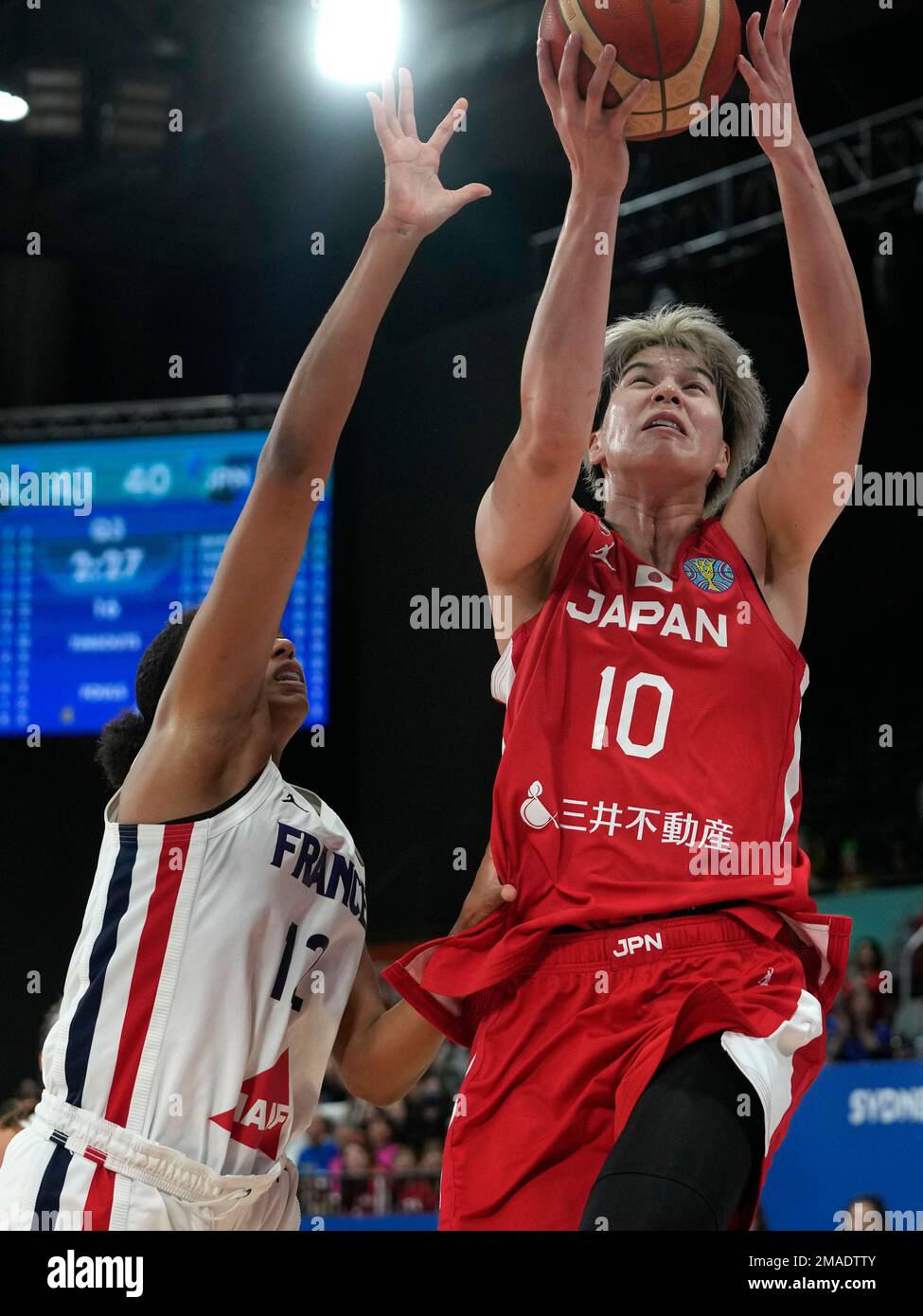 Japan's Ramu Tokashiki, right, lays the ball up over France's Iliana ...