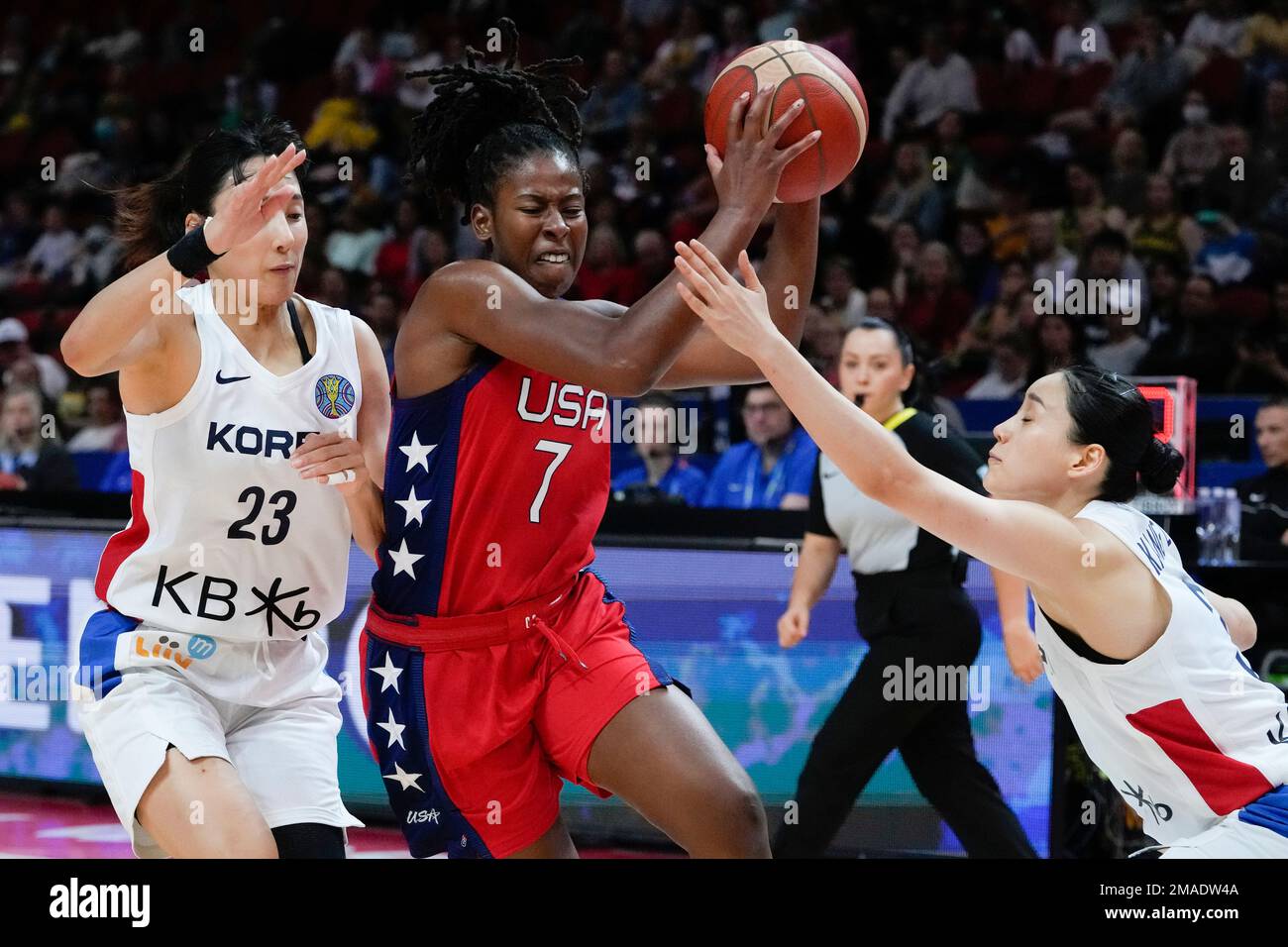 United States' Ariel Atkins, centre, runs past South Korea's Kim Danbi ...