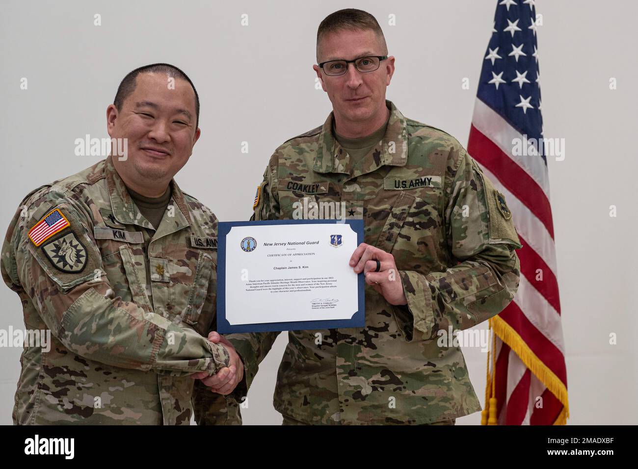 U.S. Army Brig. Gen. Timothy A. Coakley, right, presents Chaplain Maj ...