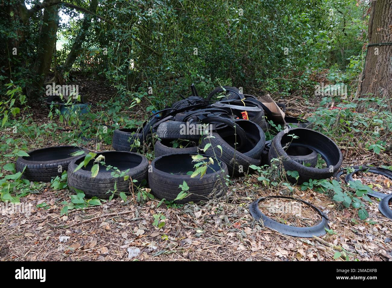 Fly-tipping off a pile of car tyres in a country lane Stock Photo - Alamy
