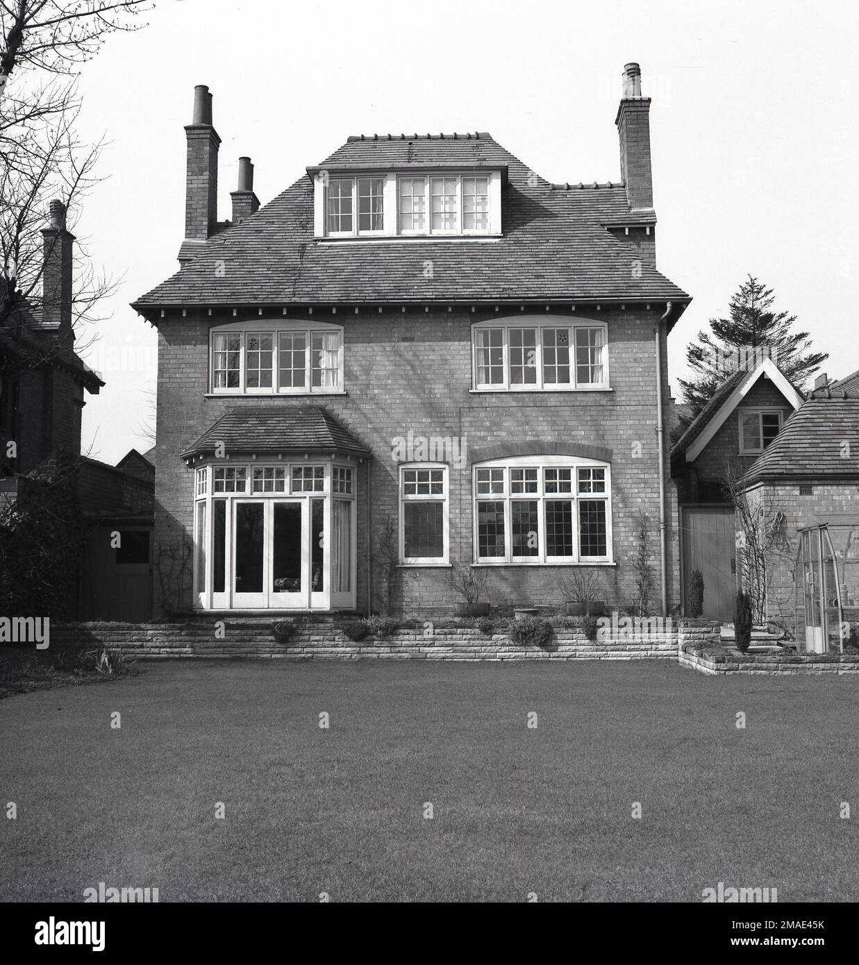 1960s, historical, rear view, from back garden, of a large, brick-buit ...