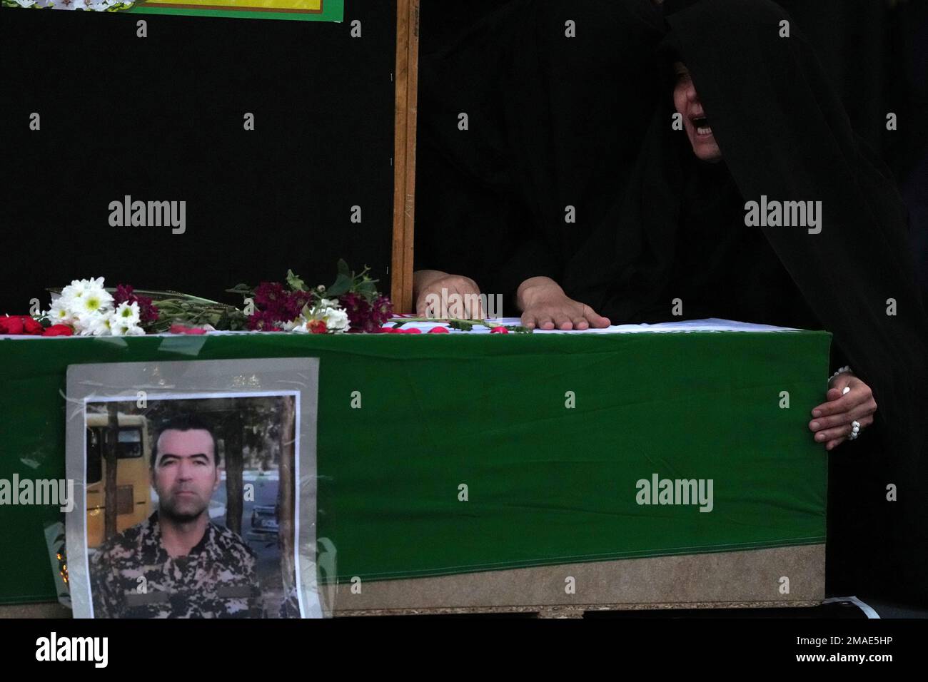 Wife of Hossein Taghipour cries over the flag-draped coffin of her ...