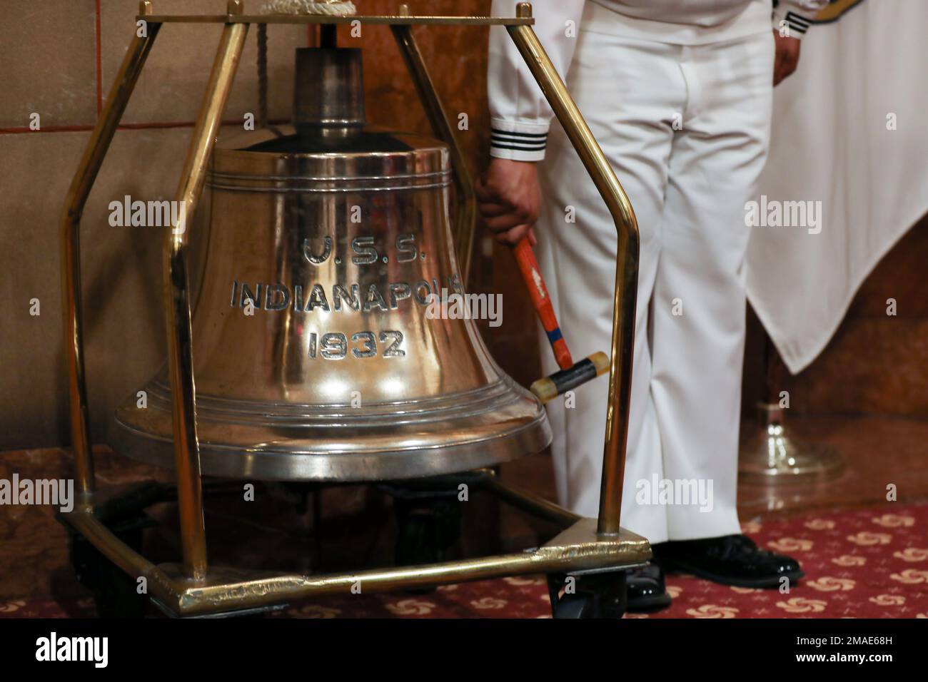 Navy service member rings the U.S.S. Indianapolis bell in honor of the ...