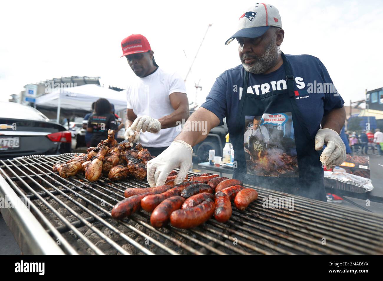 Rick Chance, left, and Jonathan Gates, right, both of Boston, cook on a ...