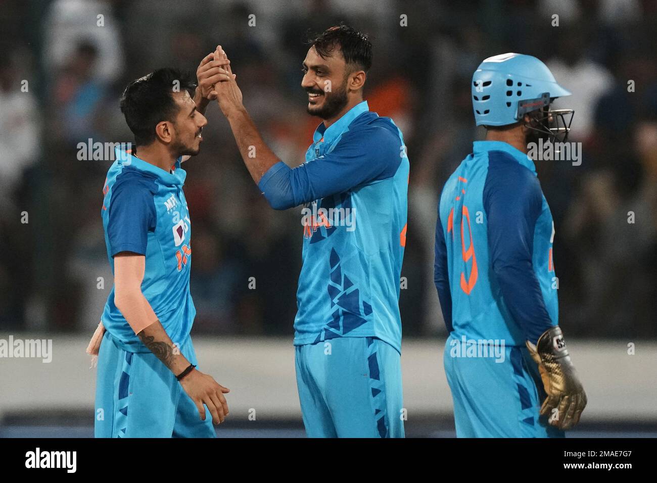 India's Axar Patel, center, celebrates with teammates after the ...