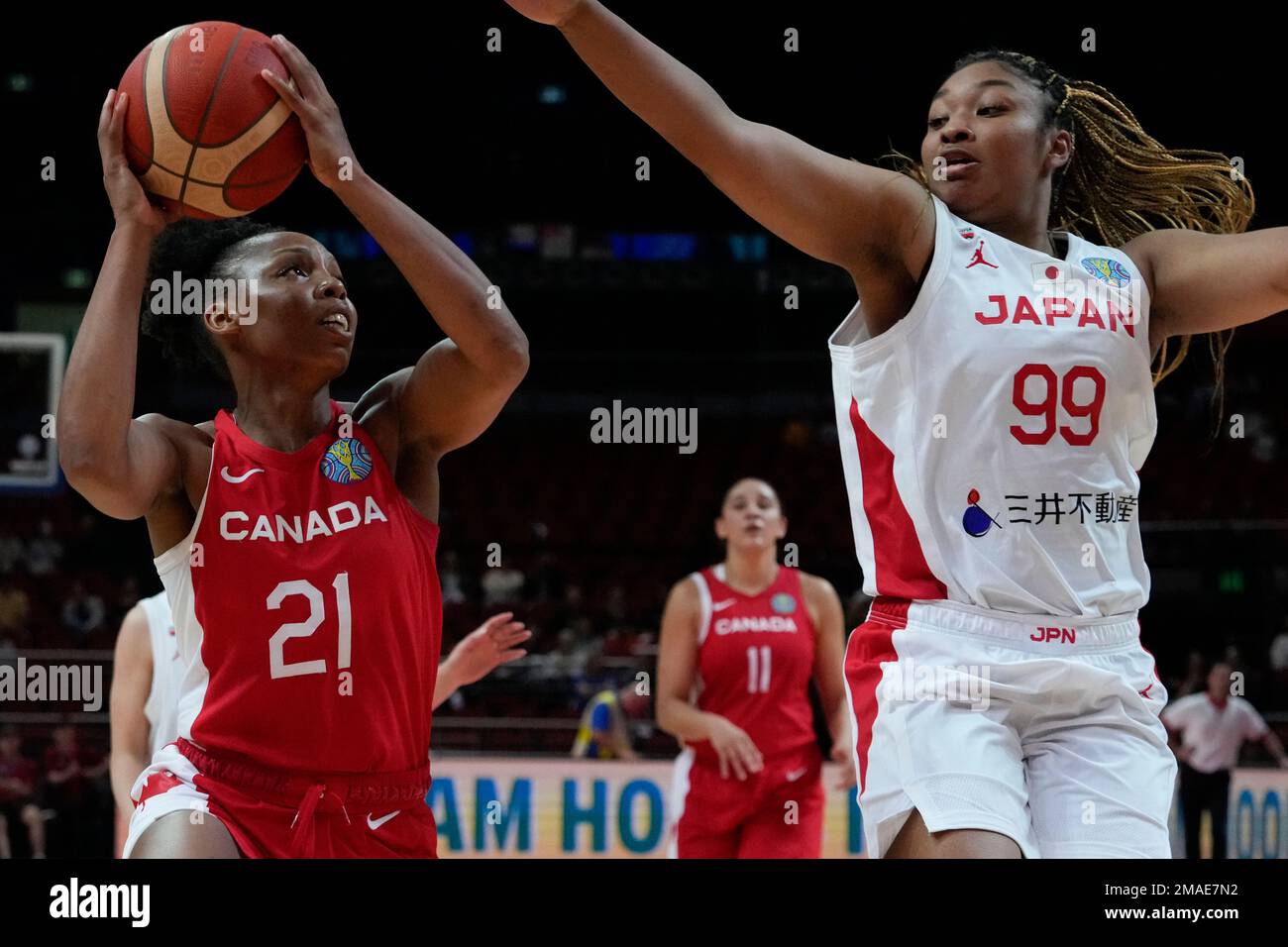 Canada's Nirra Fields shoots for goal as Japan's Monica Okoye attempts to block during their ...