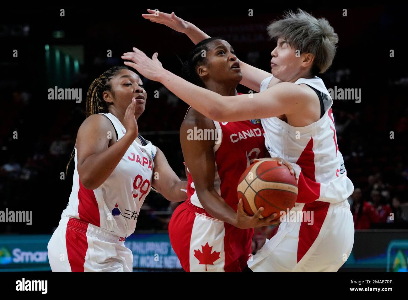Canada's Shay Colley, runs between Japan's Monica Okoye, left, and Ramu ...