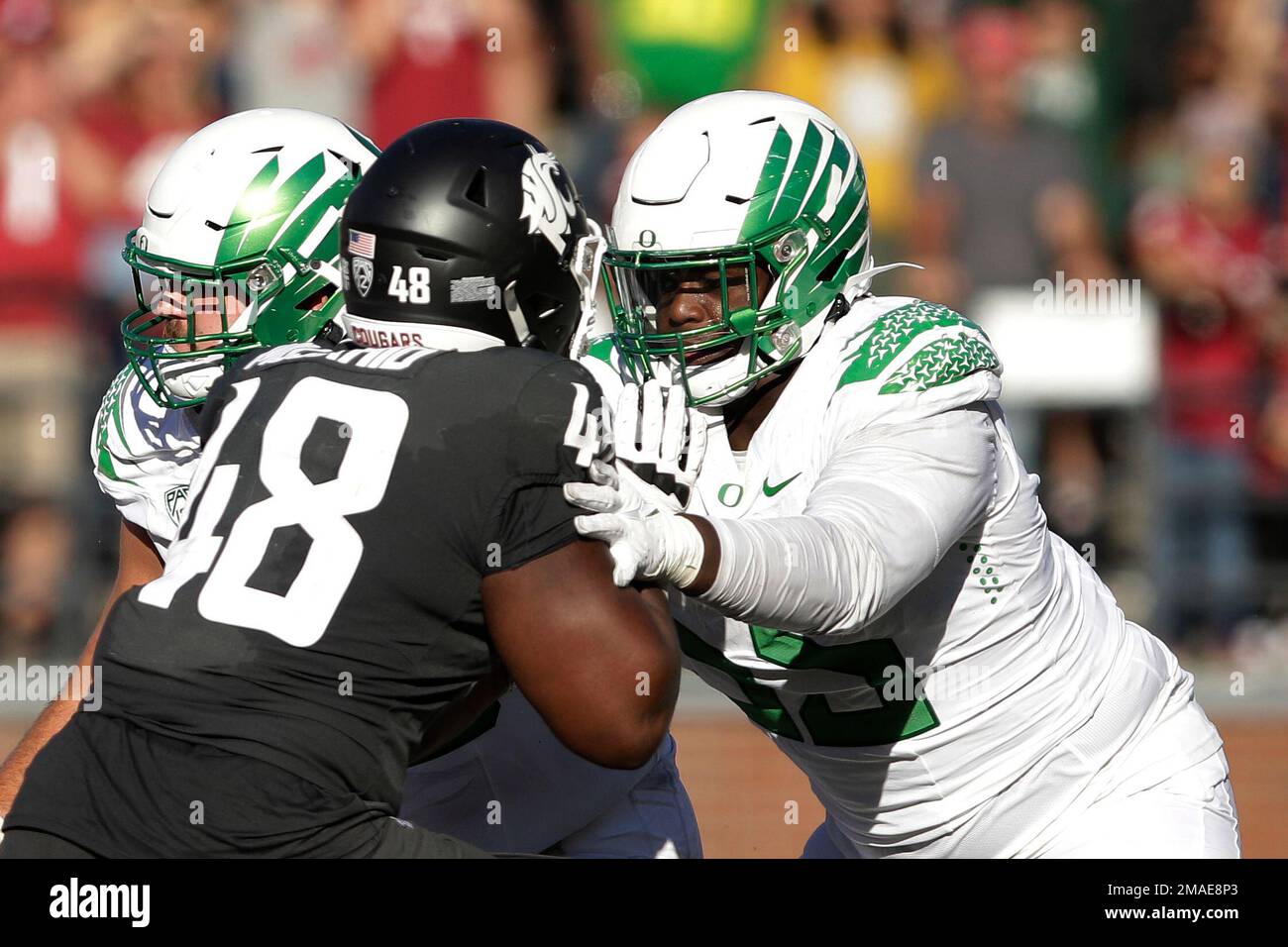 Oregon offensive lineman Marcus Harper II, right, blocks Washington ...