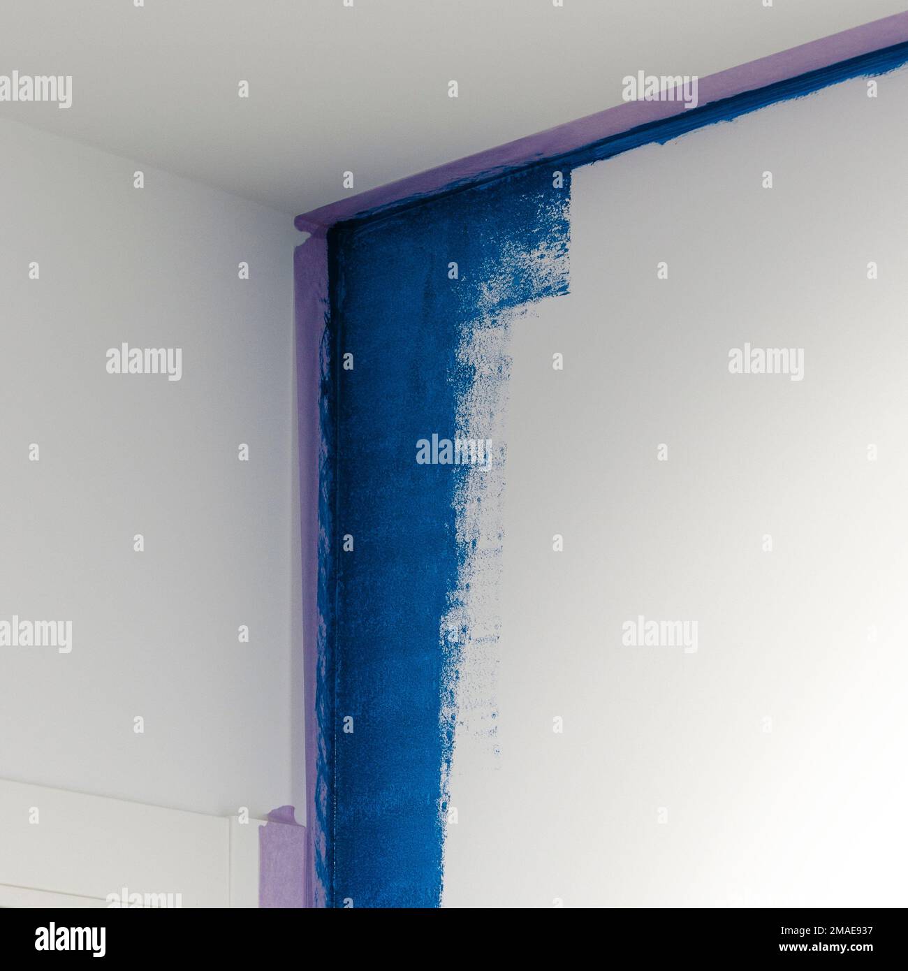 Repair. White wall in blue staining process Stock Photo - Alamy