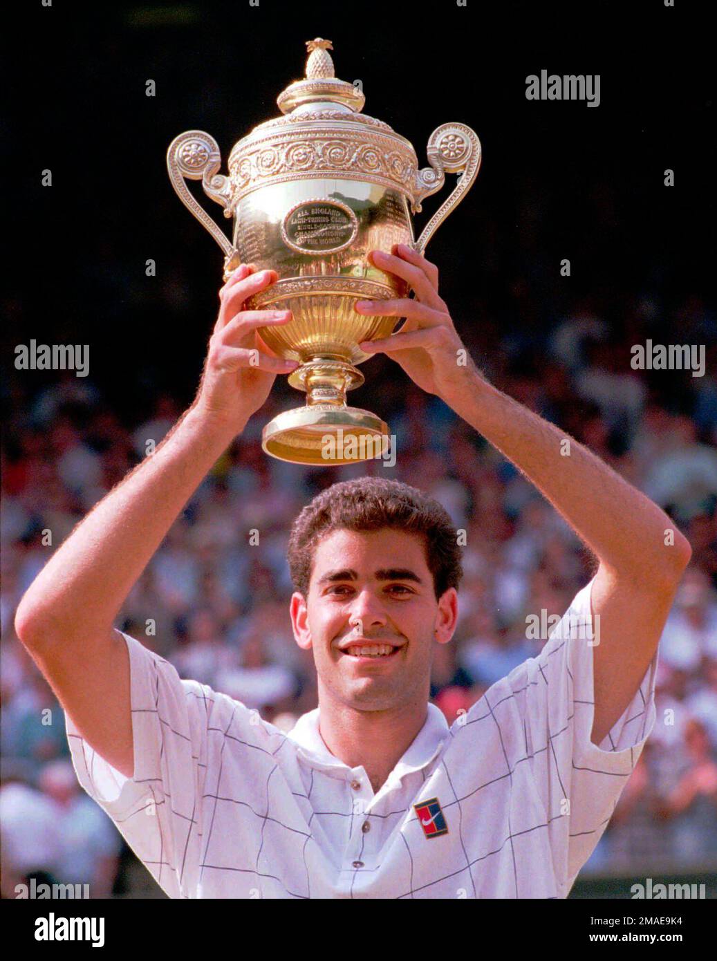 FILE - Pete Sampras holds his trophy, after defeating Boris Becker to ...