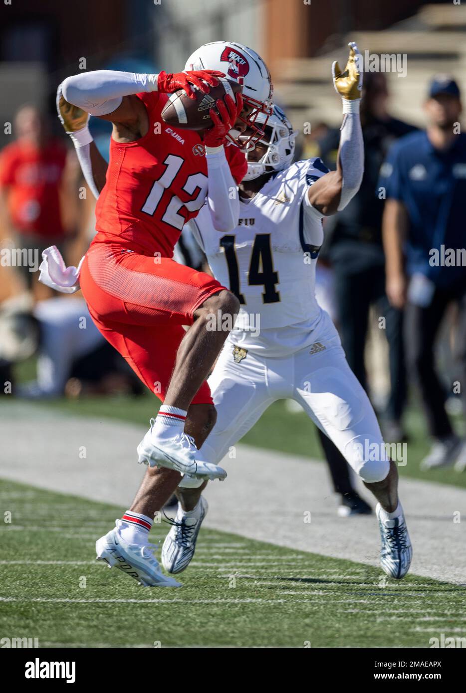 WKU defensive back Kahlef Hailassie, 12, intercepts a pass in front of ...
